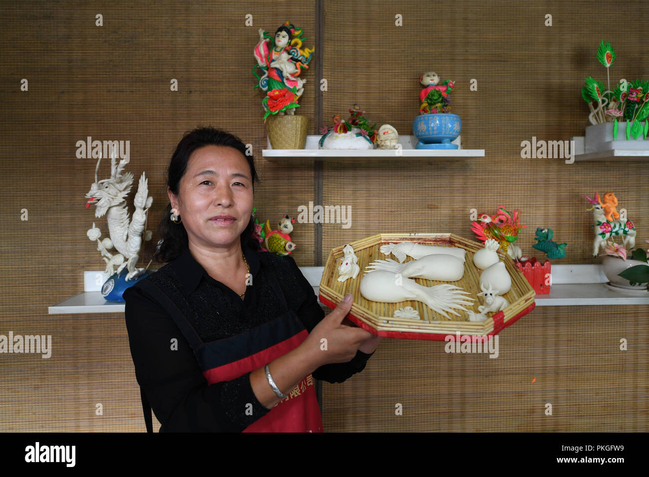 Lanxian, China's Shanxi Province. 13th Sep, 2018. A villager displays ...