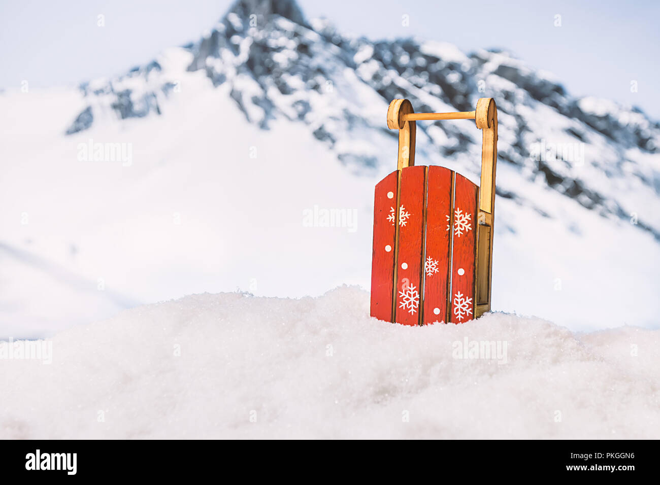 Sleigh in a snowdrift in front of snowy mountains. Winter Christmas ...
