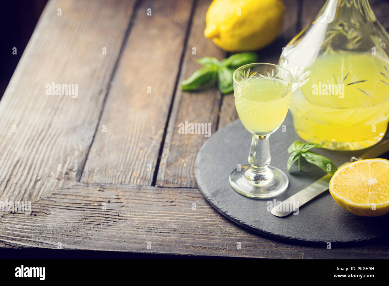 Traditional italian lemon liqueur limoncello and fresh citrus lemon ...