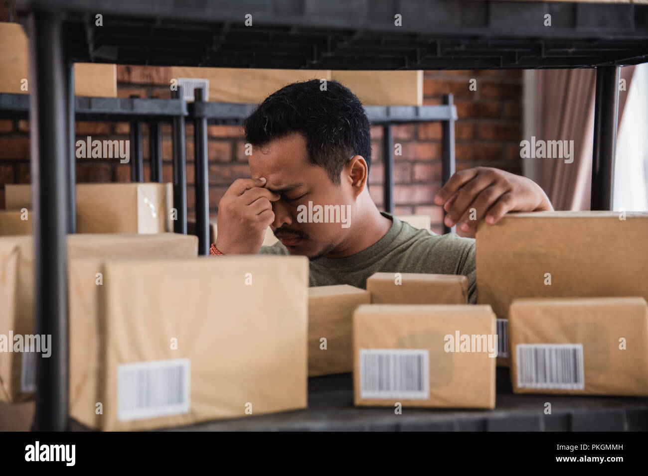 stressed young man checking packages Stock Photo - Alamy