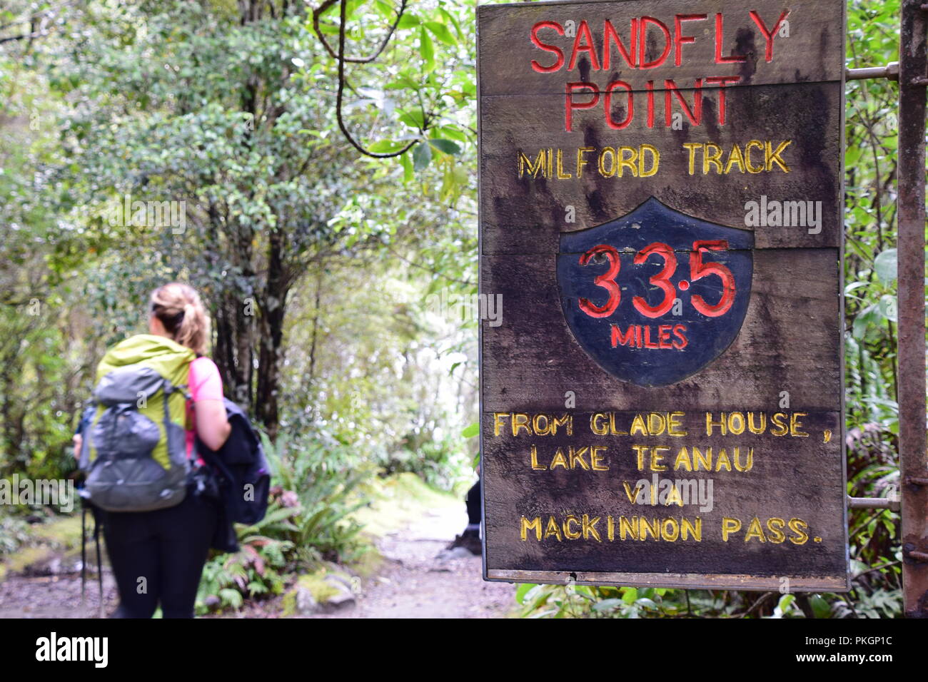 Backpacker arriving at Sandfly point on Milford Track New Zealand Stock ...
