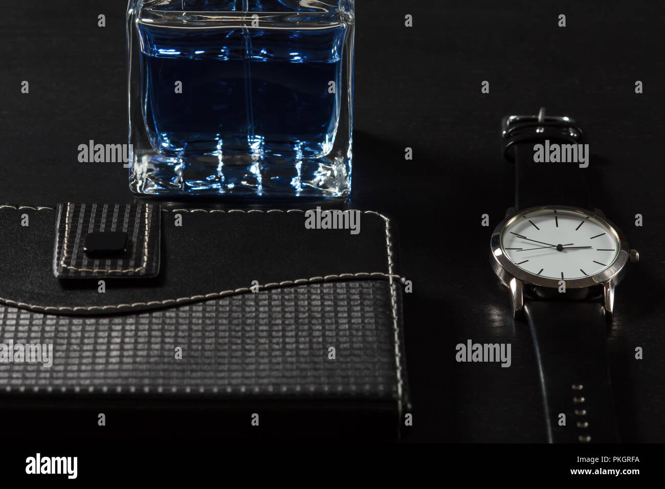 Man perfume, watch with a leather strap, notebook in leather cover on a ...