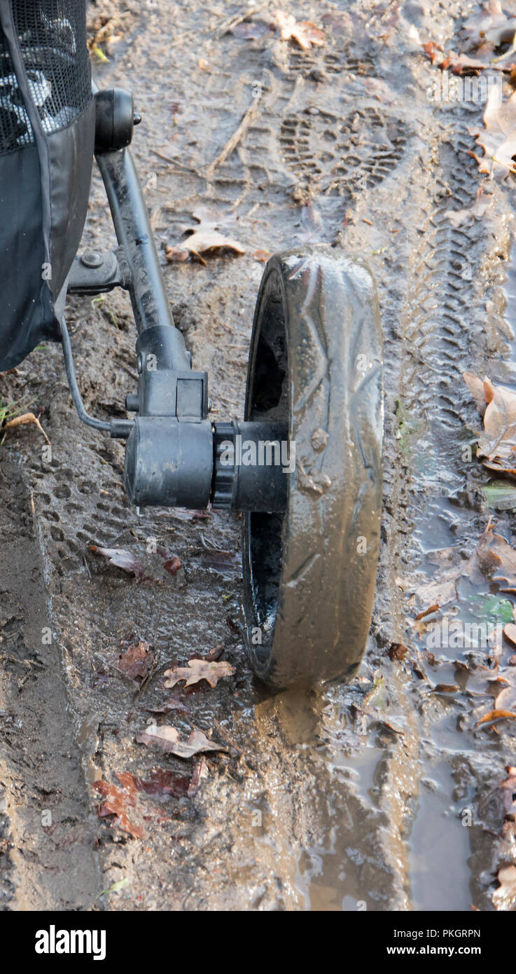Dirty, mud baby stroller wheels in the muddy ground close up photo ...