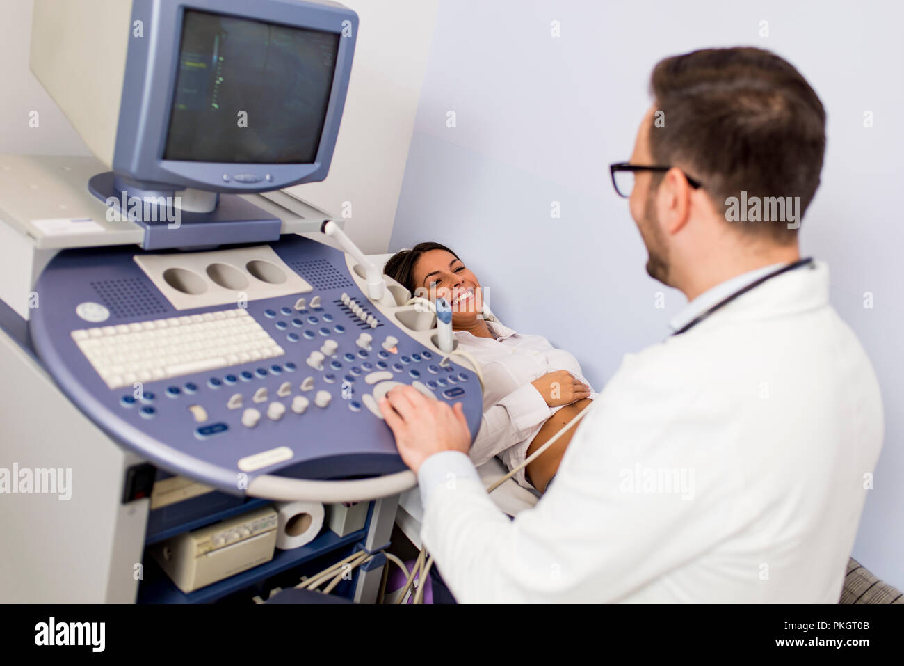 Doctor doing medical examination of patient with ultra sound scanner ...