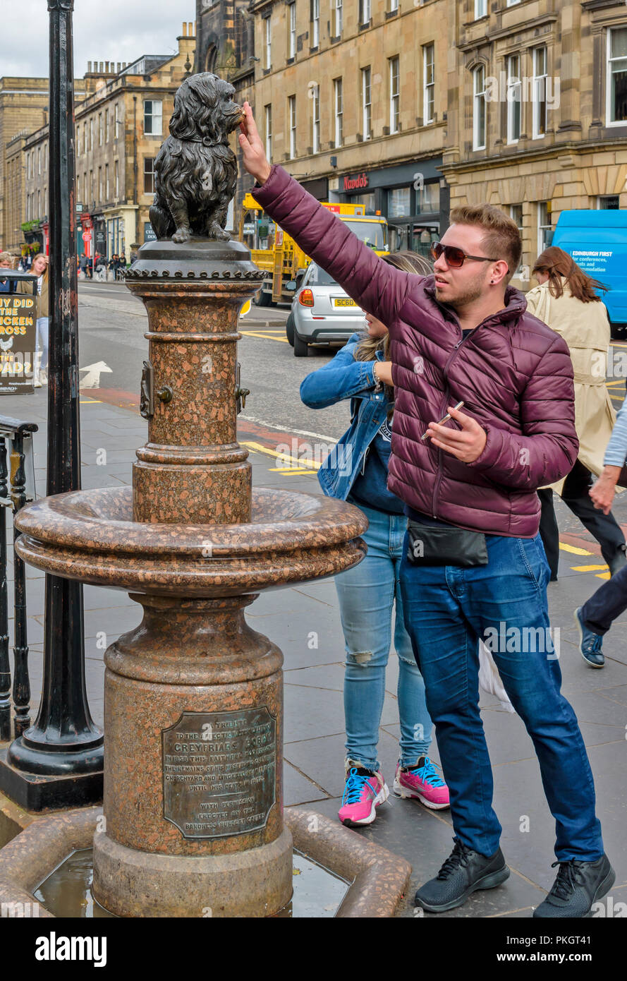 EDINBURGH SCOTLAND REACHING UP TO TOUCH THE NOSE OF GREYFRIARS BOBBY ...