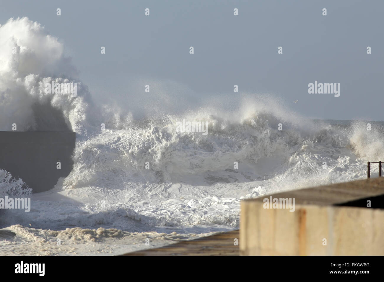 Big strong sea waves against piers in a stormy but clear day Stock ...