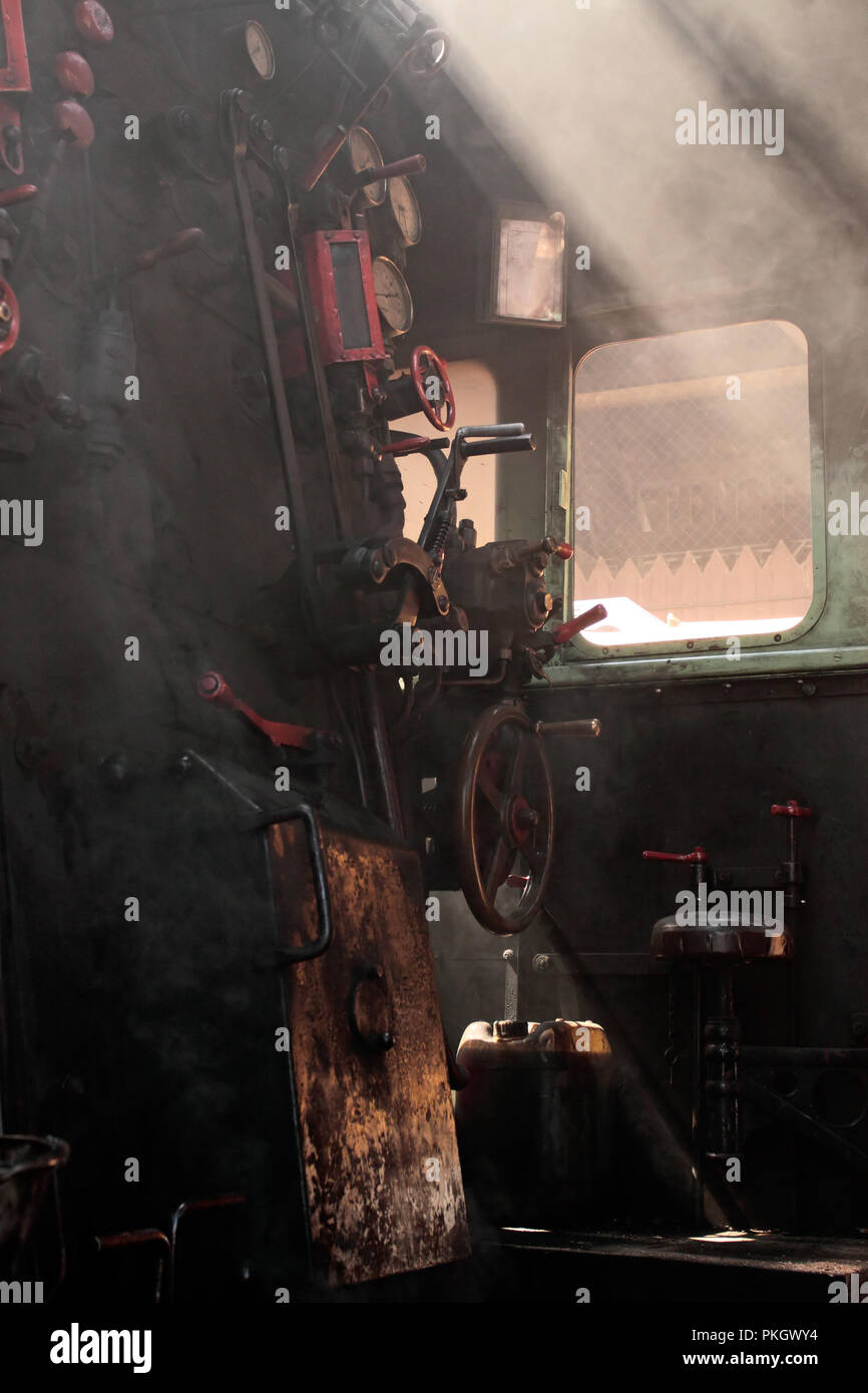 Details of a vintage steam train driving cabin, just before departure ...