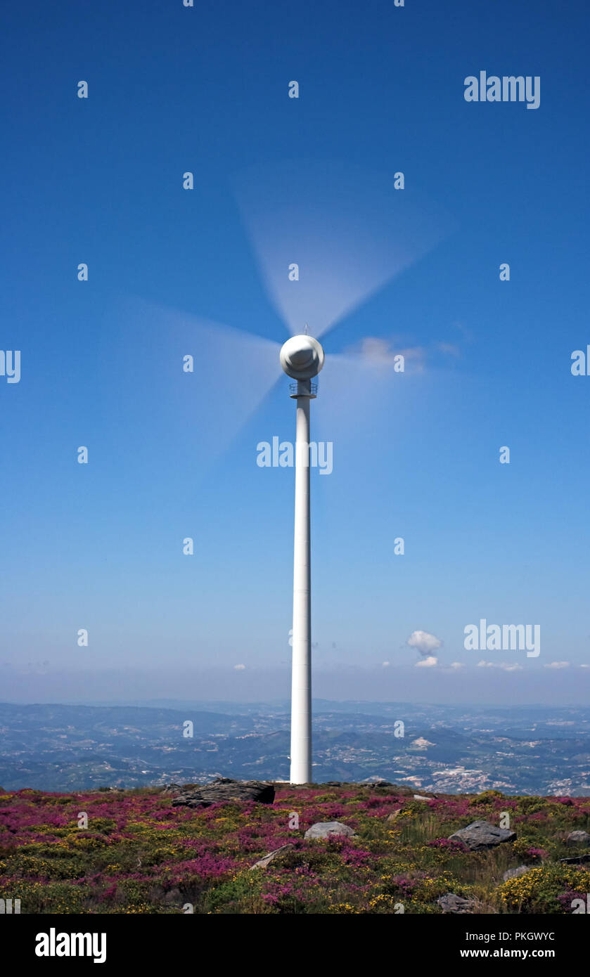 Wind turbin in the pick of a mountain in motion Stock Photo - Alamy