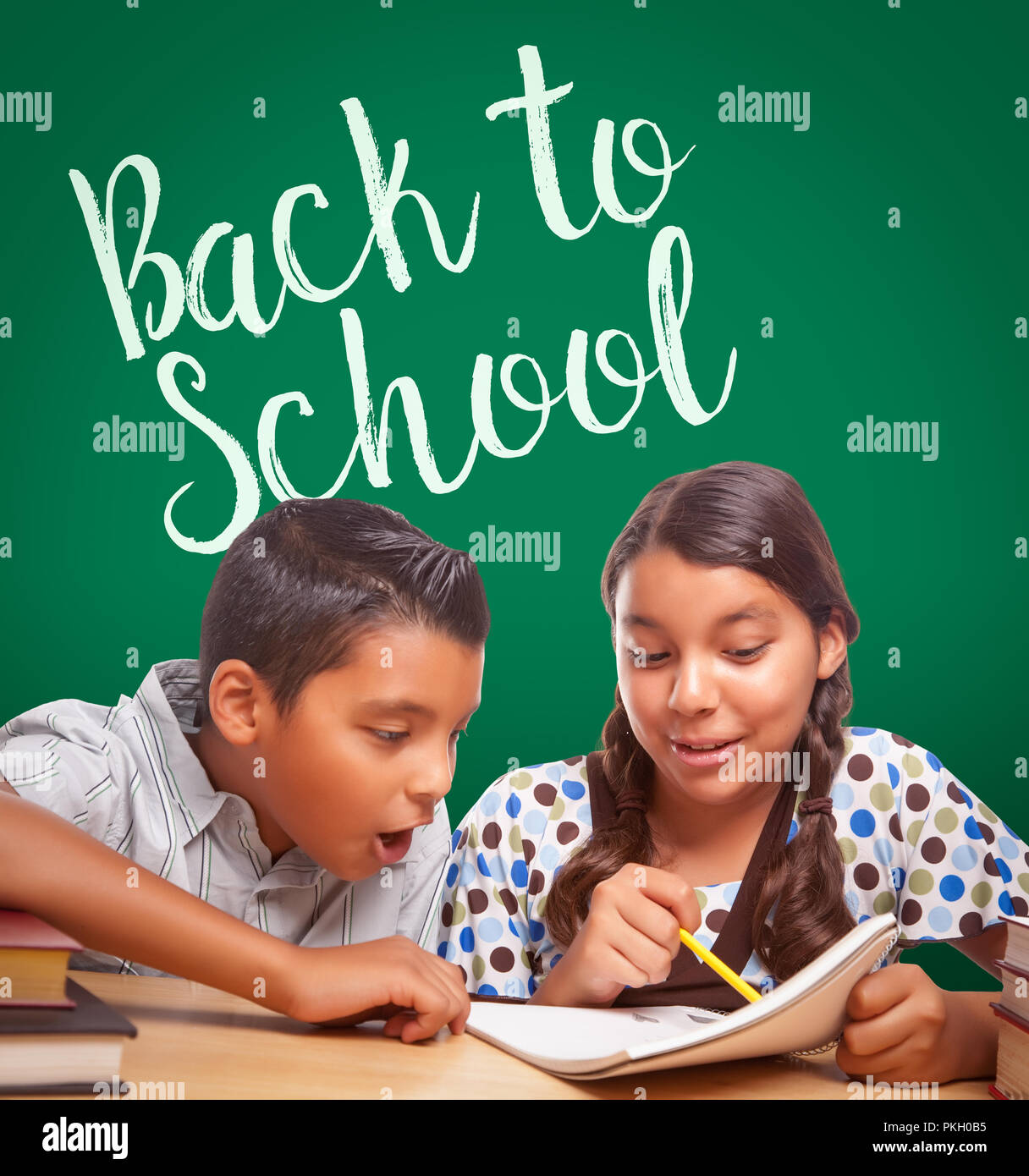 Back To School Written On Chalk Board Behind Hispanic Boy and Girl ...