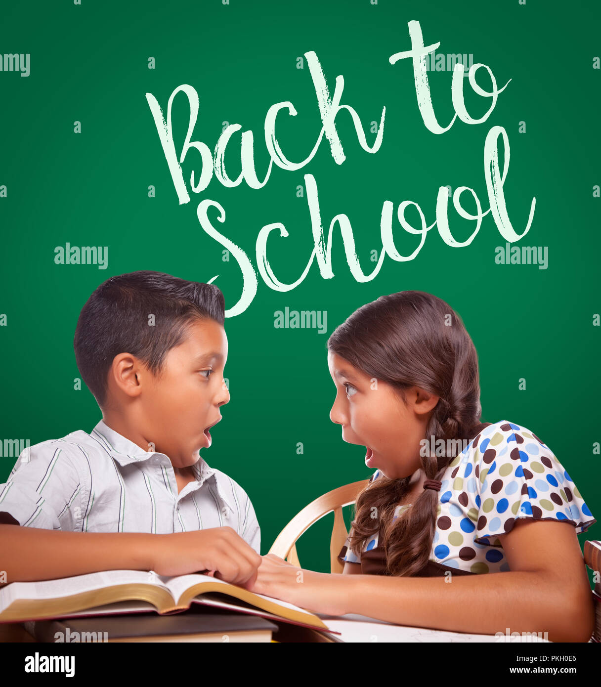 Back To School Written On Chalk Board Behind Hispanic Boy and Girl ...