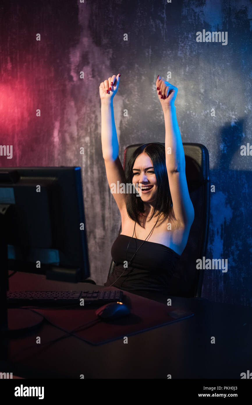 Portrait of ecstatic gamer girl in headphones screaming and rejoicing ...