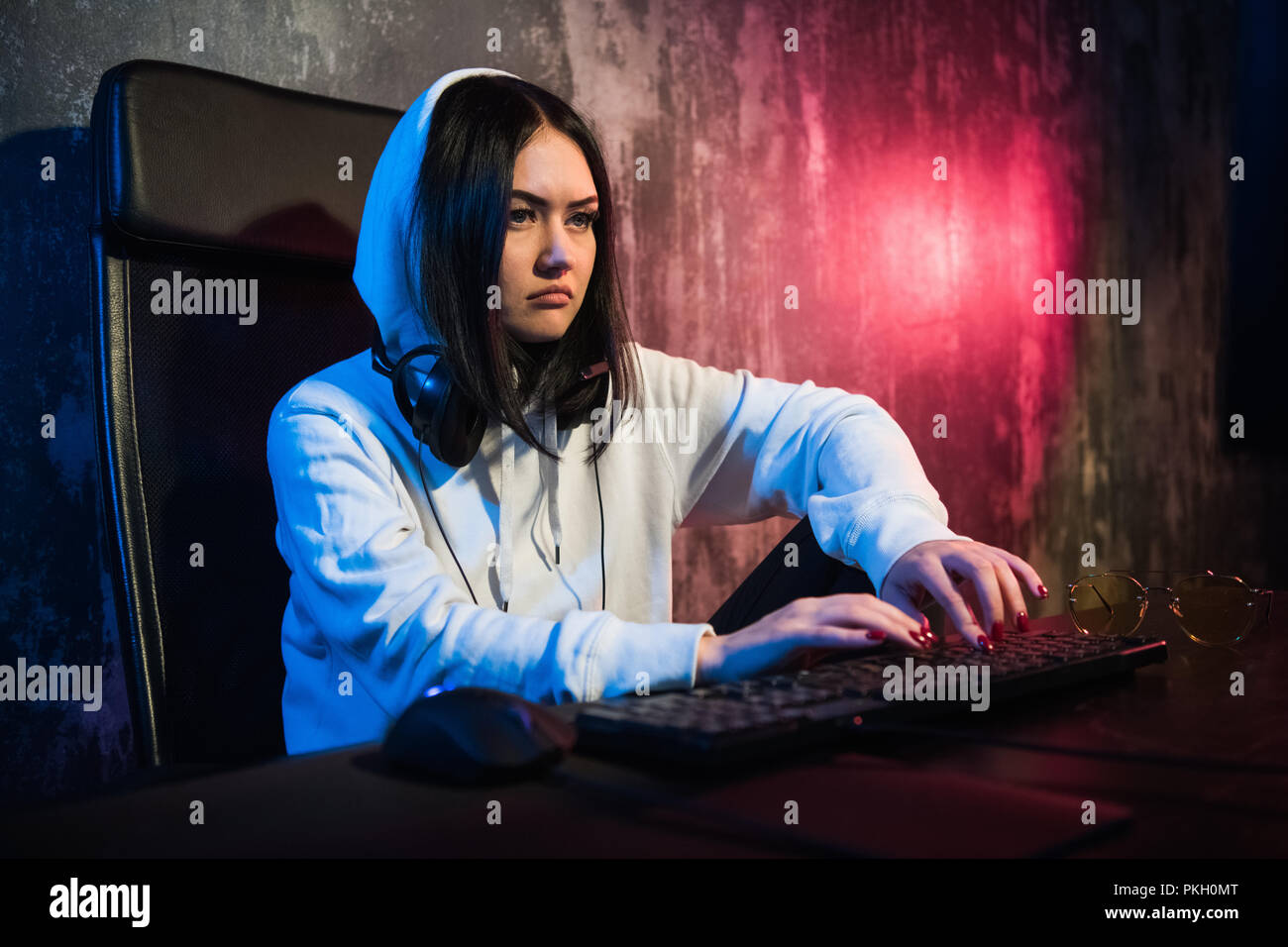 Woman hacker wearing an hood in front of computer screen Stock Photo ...