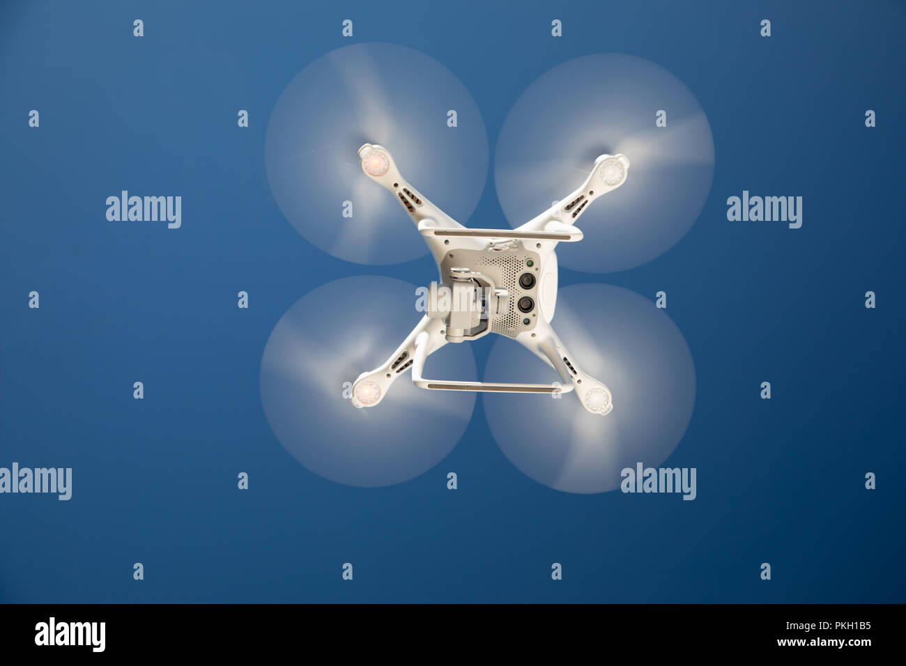 Drone Quadcopter From Below Against A Blue Sky Stock Photo - Alamy