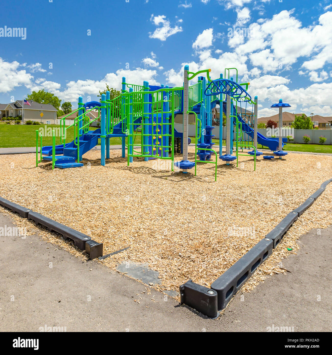 Colorful children playground with view of houses Stock Photo - Alamy