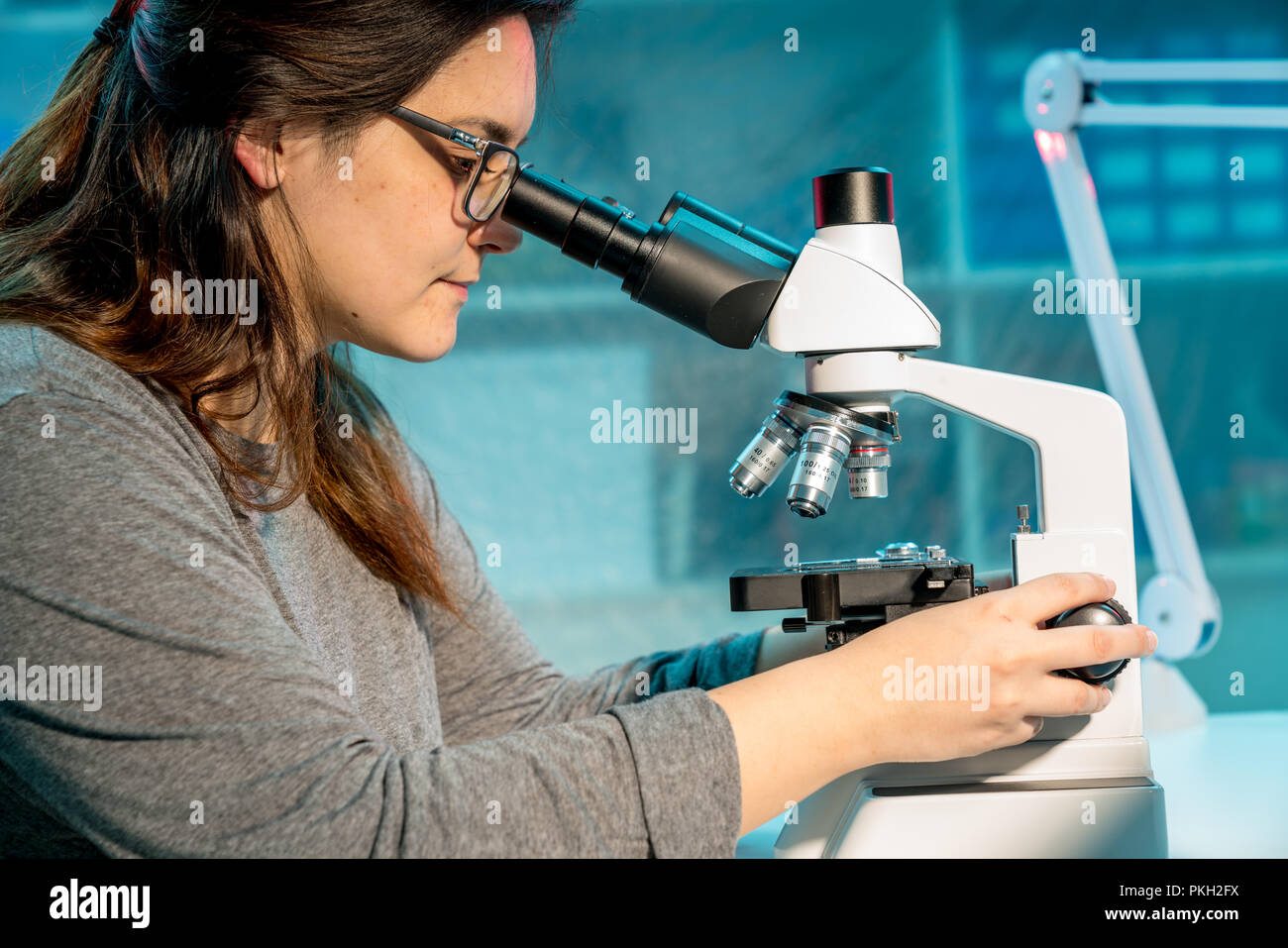 Female scientist researcher conducting an experiment in a laboratory ...
