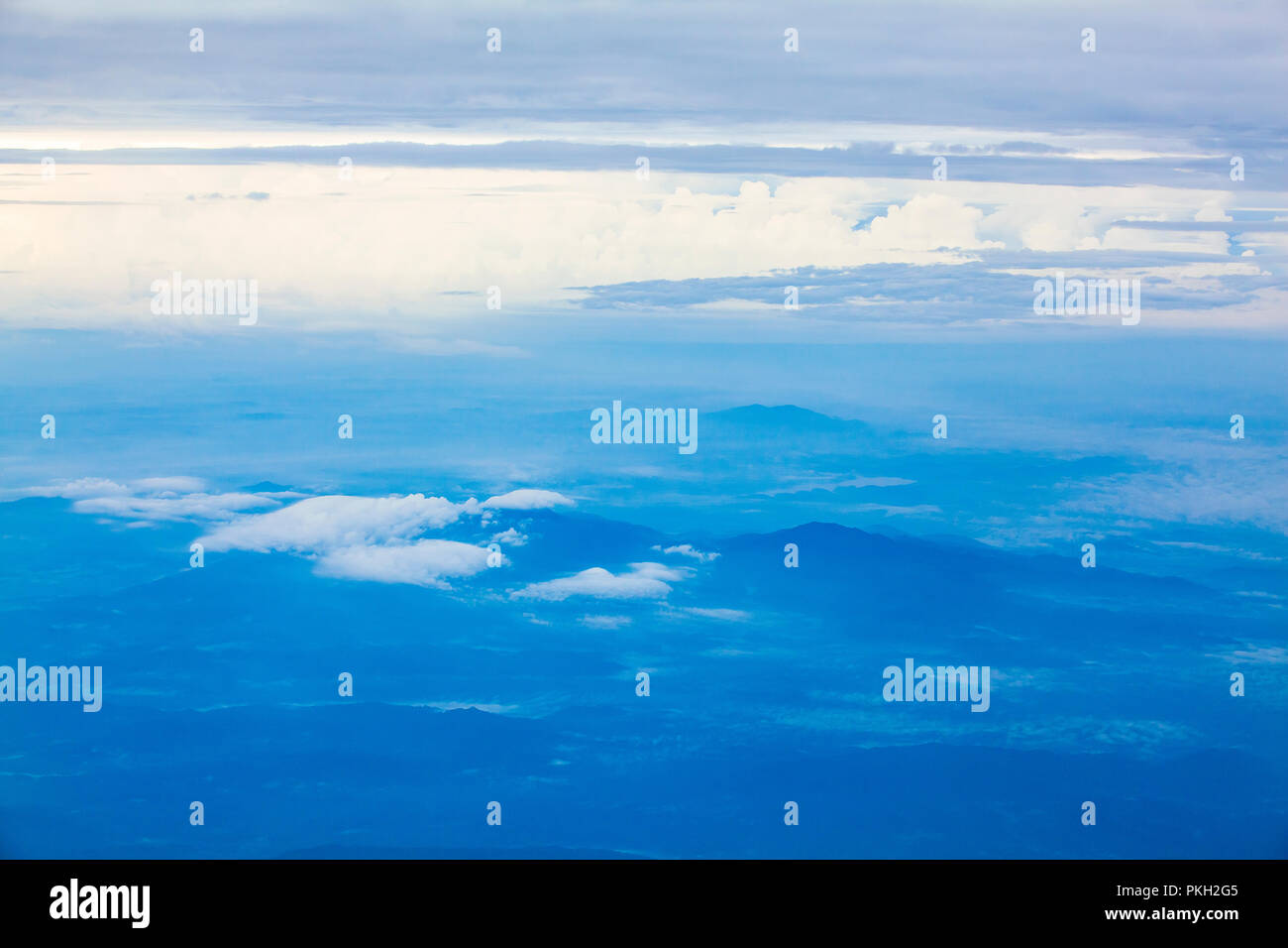 Aerial birds eye view above clouds of the blue sky Stock Photo - Alamy