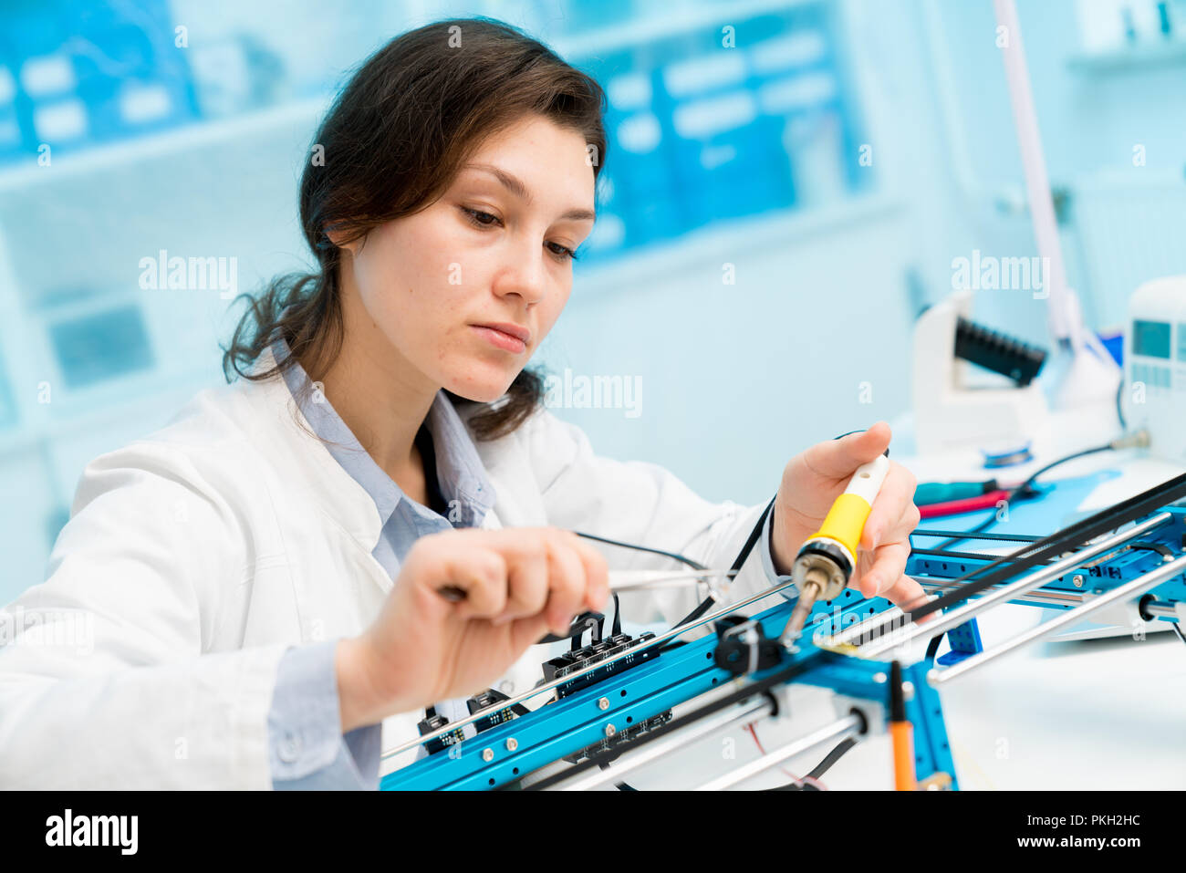 Student girl in electronics laboratory, experiment with microcontroller ...