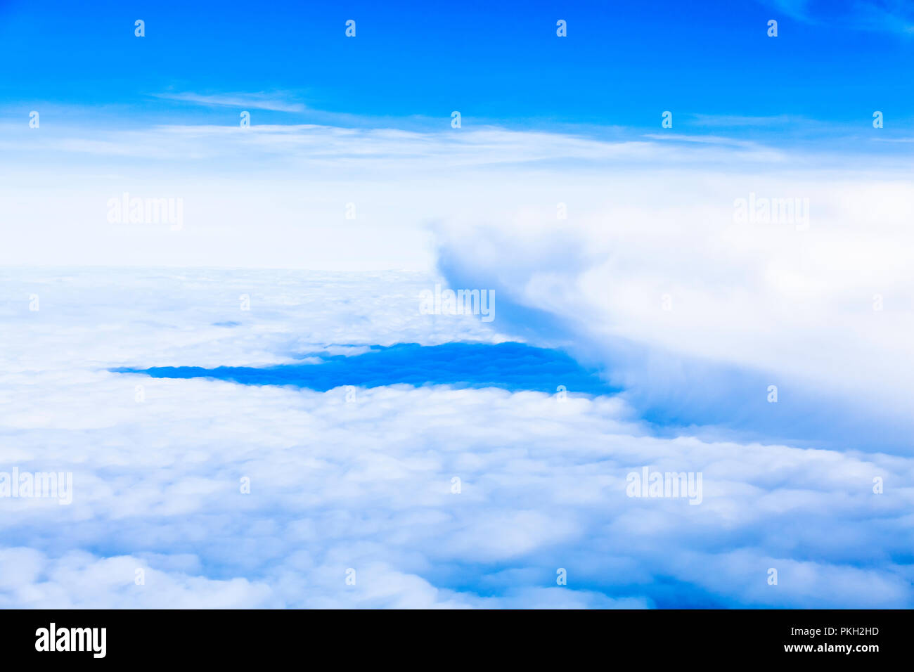 Aerial birds eye view above clouds of the blue sky Stock Photo - Alamy