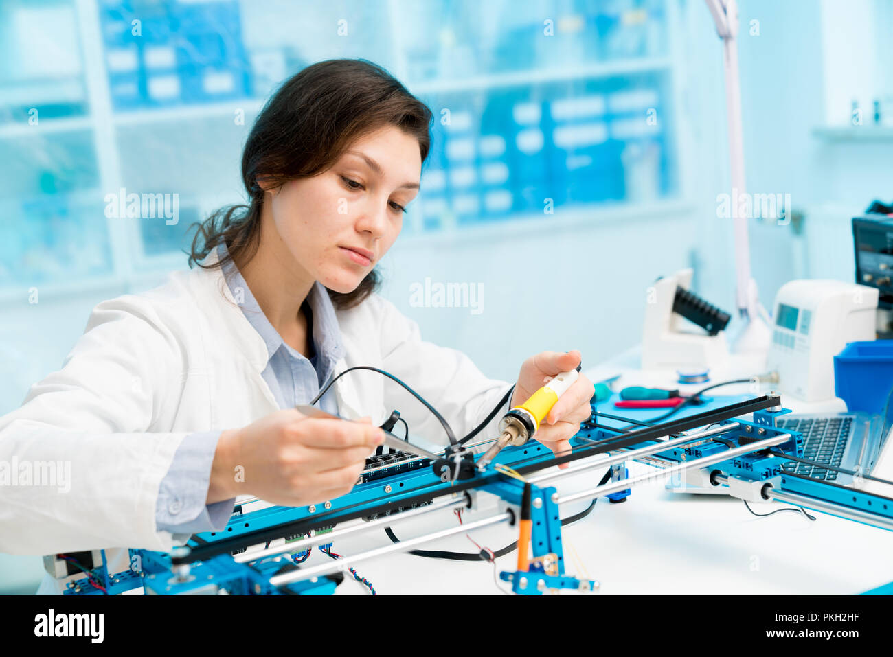 Student girl in electronics laboratory, experiment with microcontroller ...