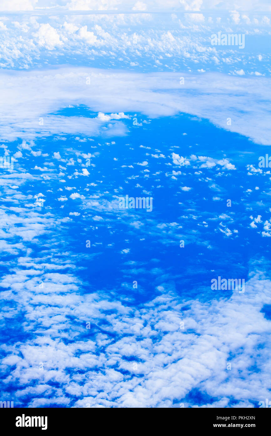 Aerial birds eye view above clouds of the blue sky Stock Photo - Alamy
