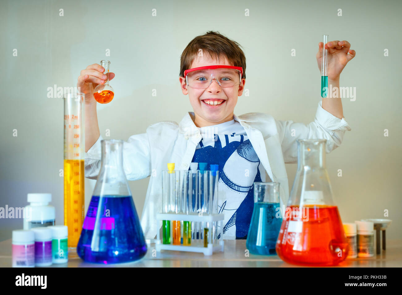 Cute boy is making science experiments in a laboratory Stock Photo - Alamy