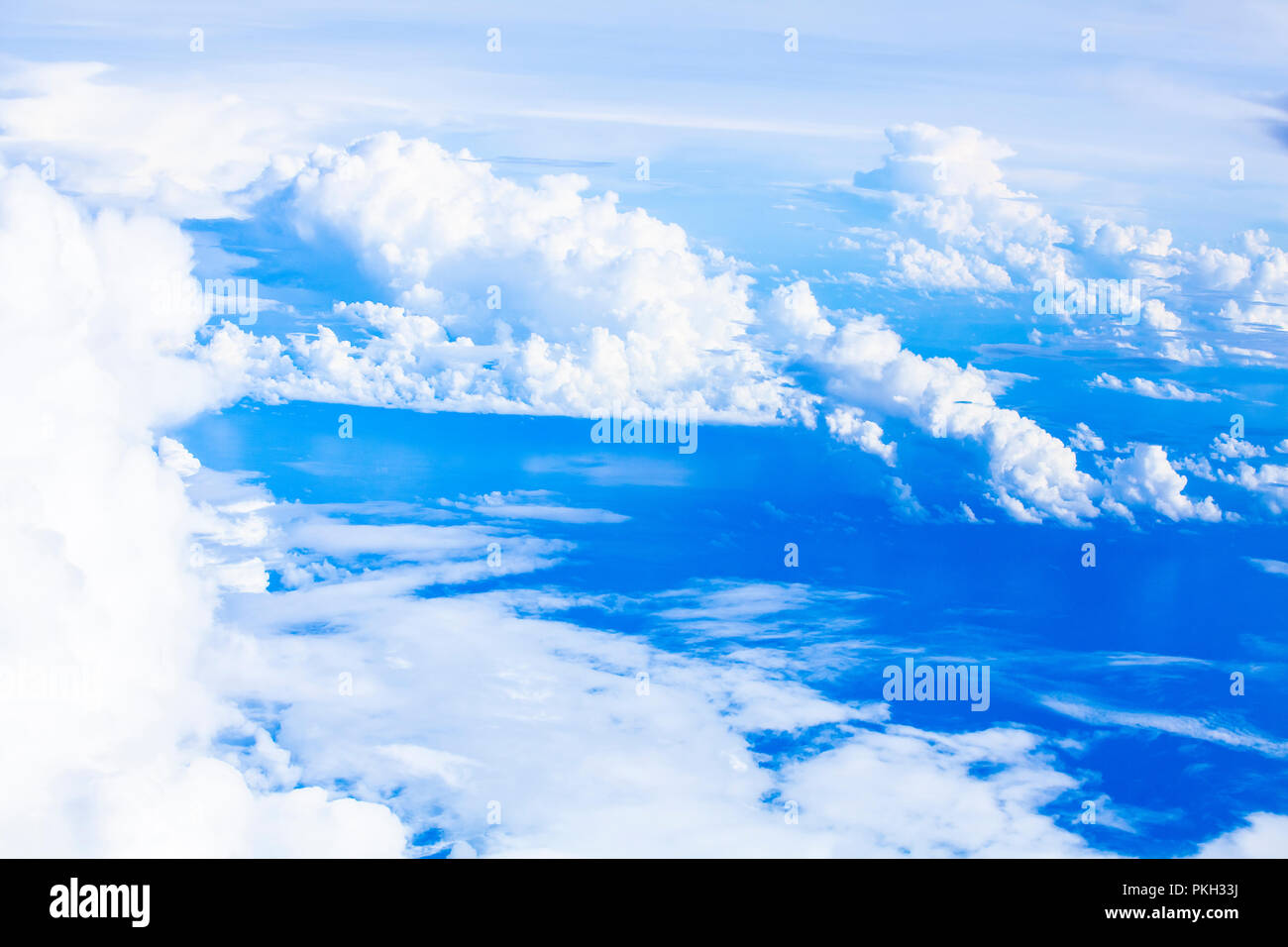 Aerial birds eye view above clouds of the blue sky Stock Photo - Alamy