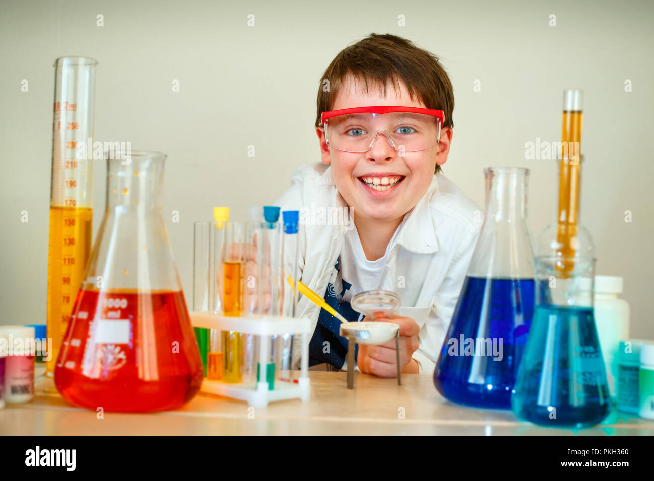 Cute boy is making science experiments in a laboratory Stock Photo - Alamy