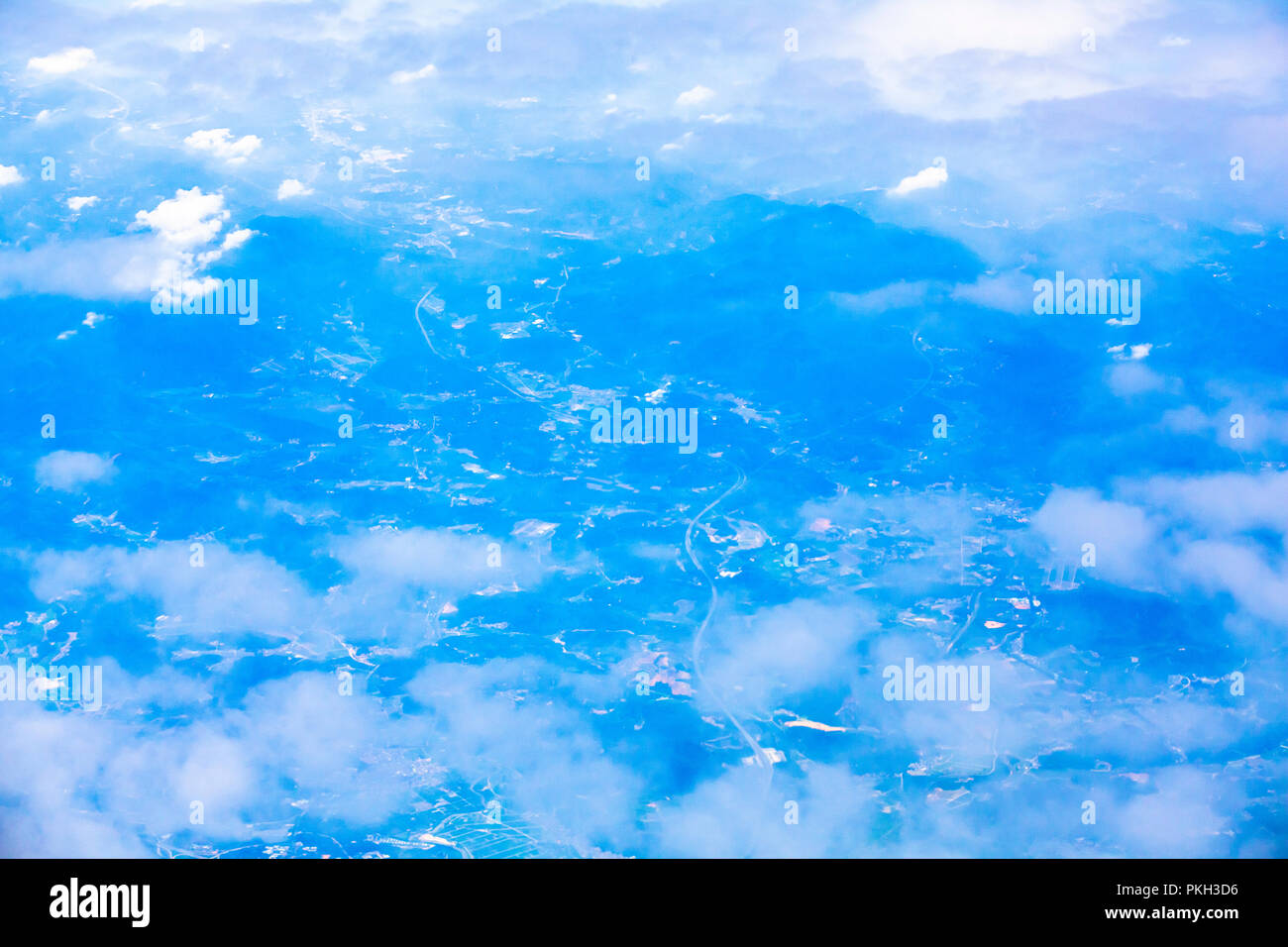 Aerial birds eye view above clouds of the blue sky Stock Photo - Alamy