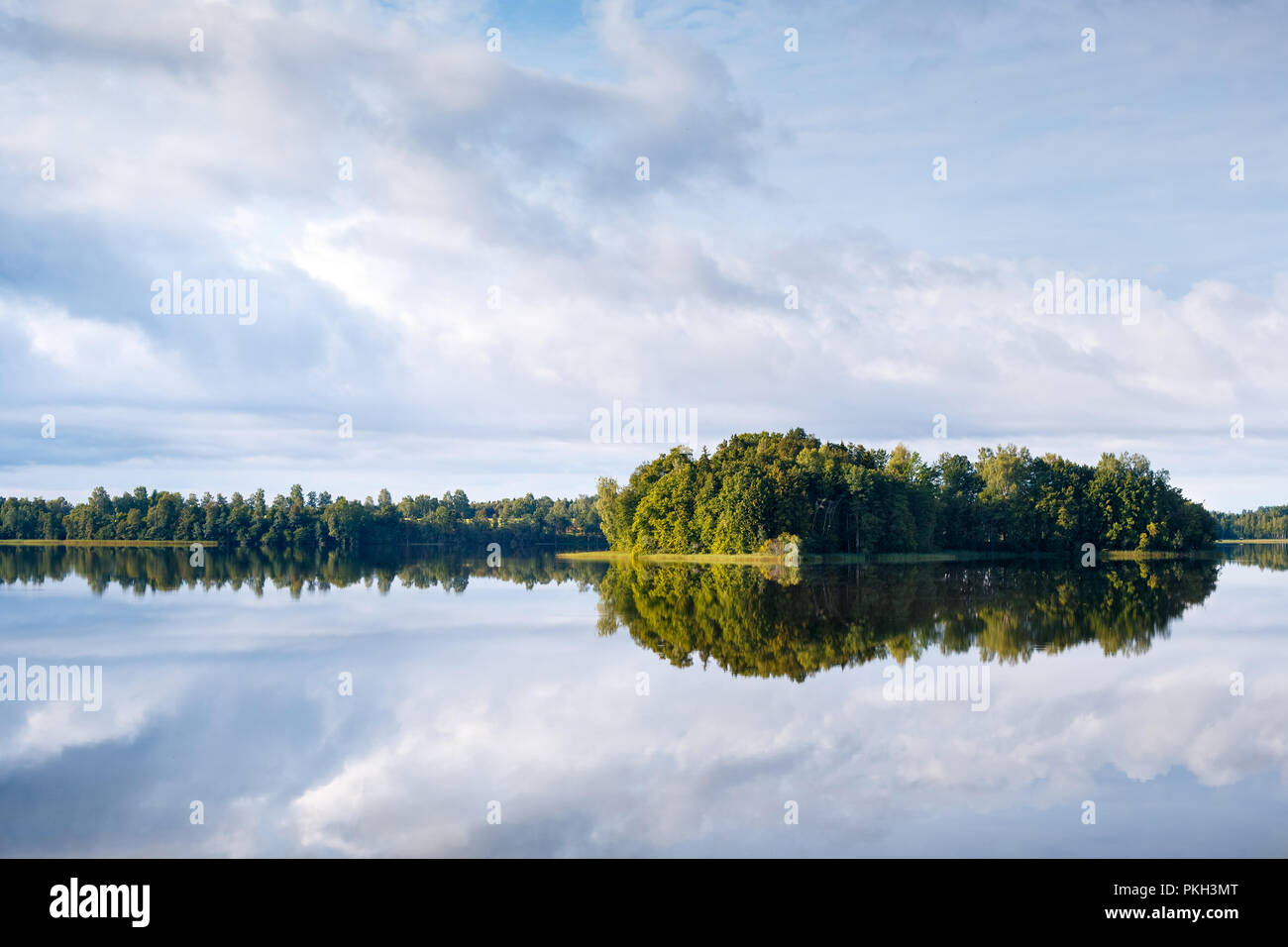 A lake, perfect reflection, clouds, and forest Stock Photo - Alamy