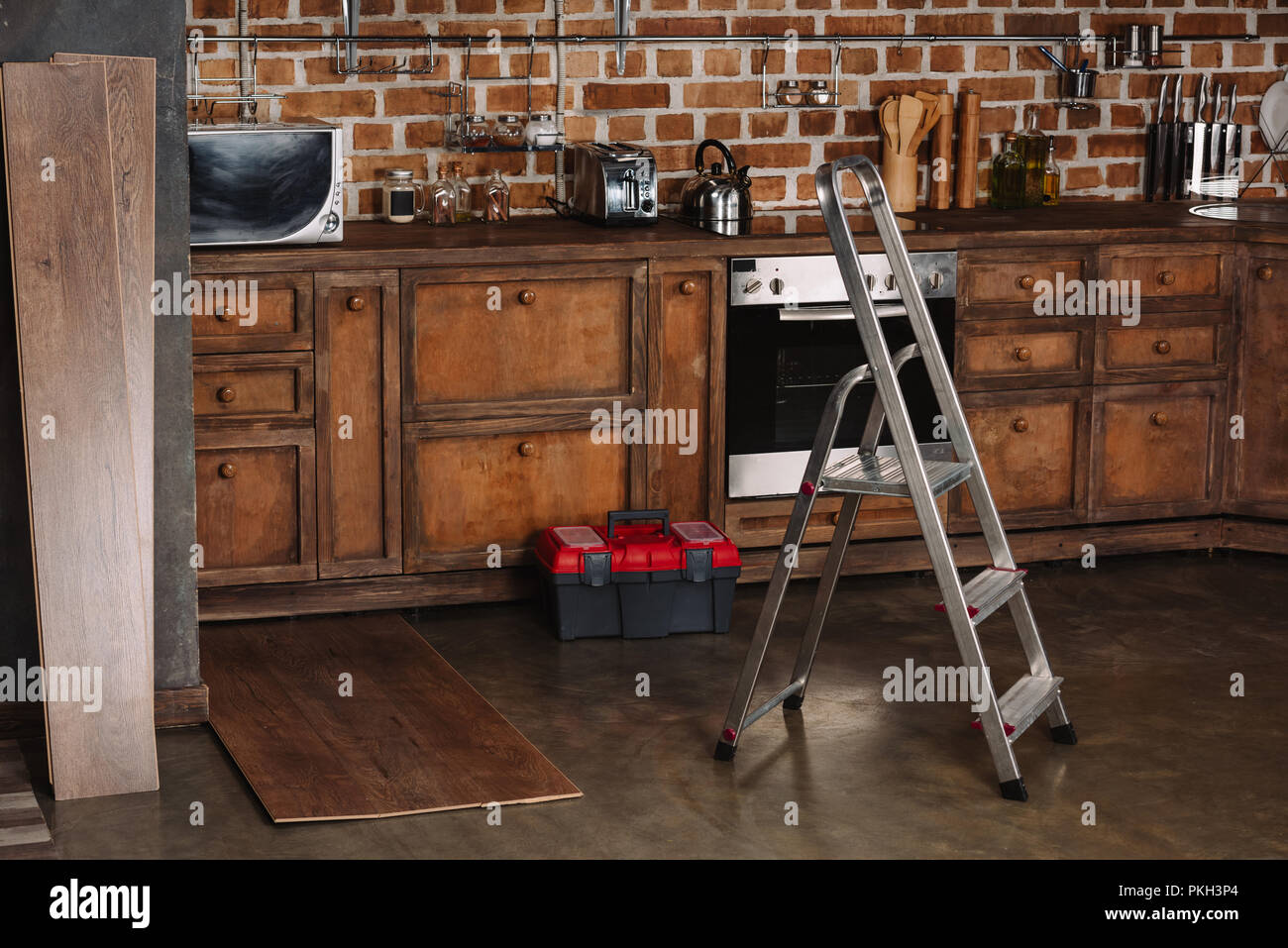 interior of loft style kitchen with stepladder, toolbox and laminate ...