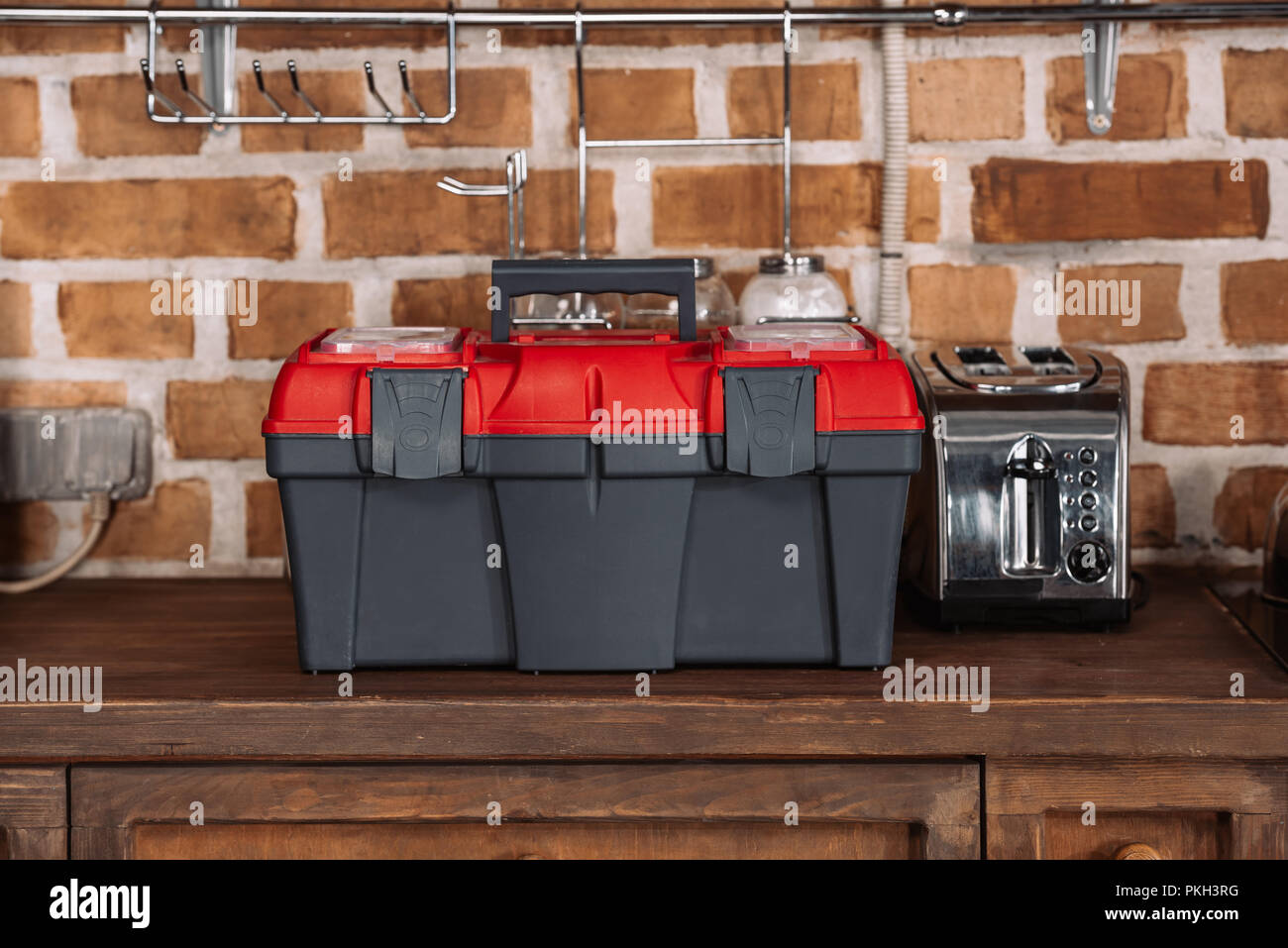 close-up shot of toolbox standing on kitchen table with toaster in ...