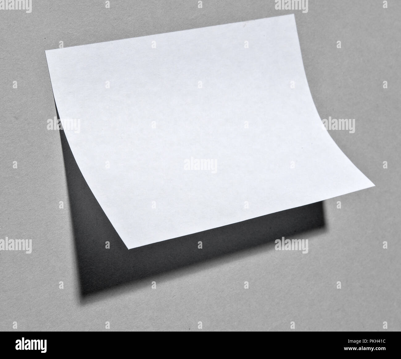 A paper note sticking on wall with shadow Stock Photo - Alamy