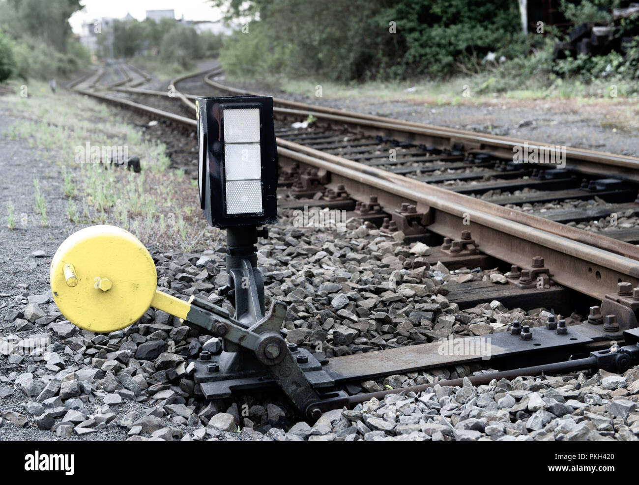 A railroad switch with tracks running to horizon Stock Photo - Alamy