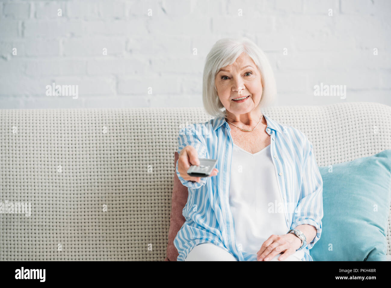 Old lady watching tv on sofa hi-res stock photography and images - Alamy