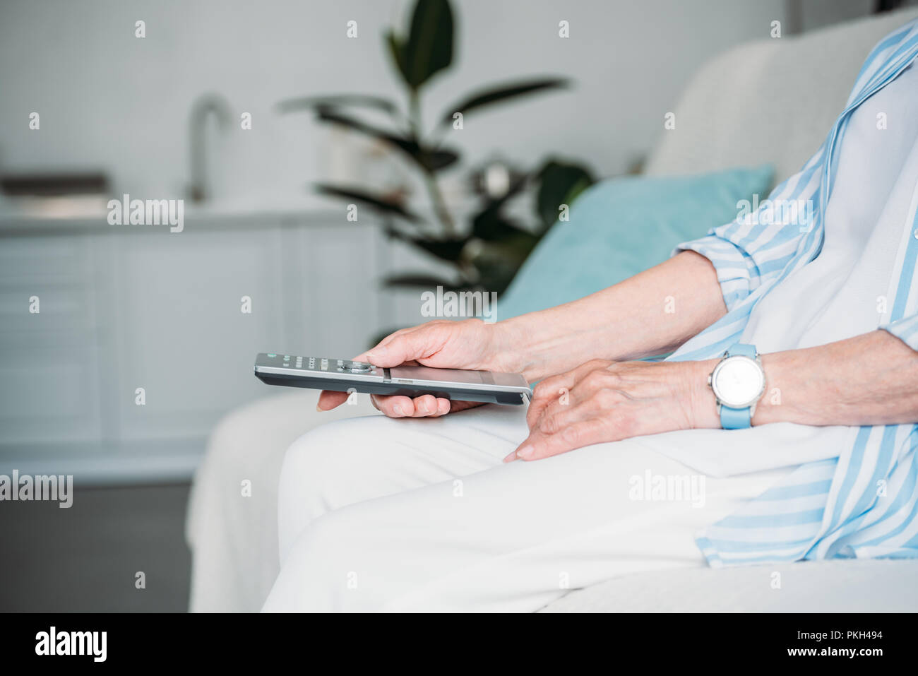 Old lady watching tv on sofa hi-res stock photography and images - Alamy