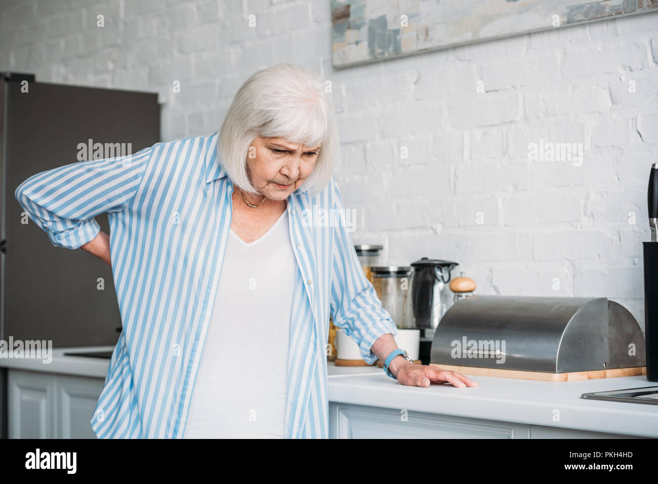 Leaning on counter hi-res stock photography and images - Alamy