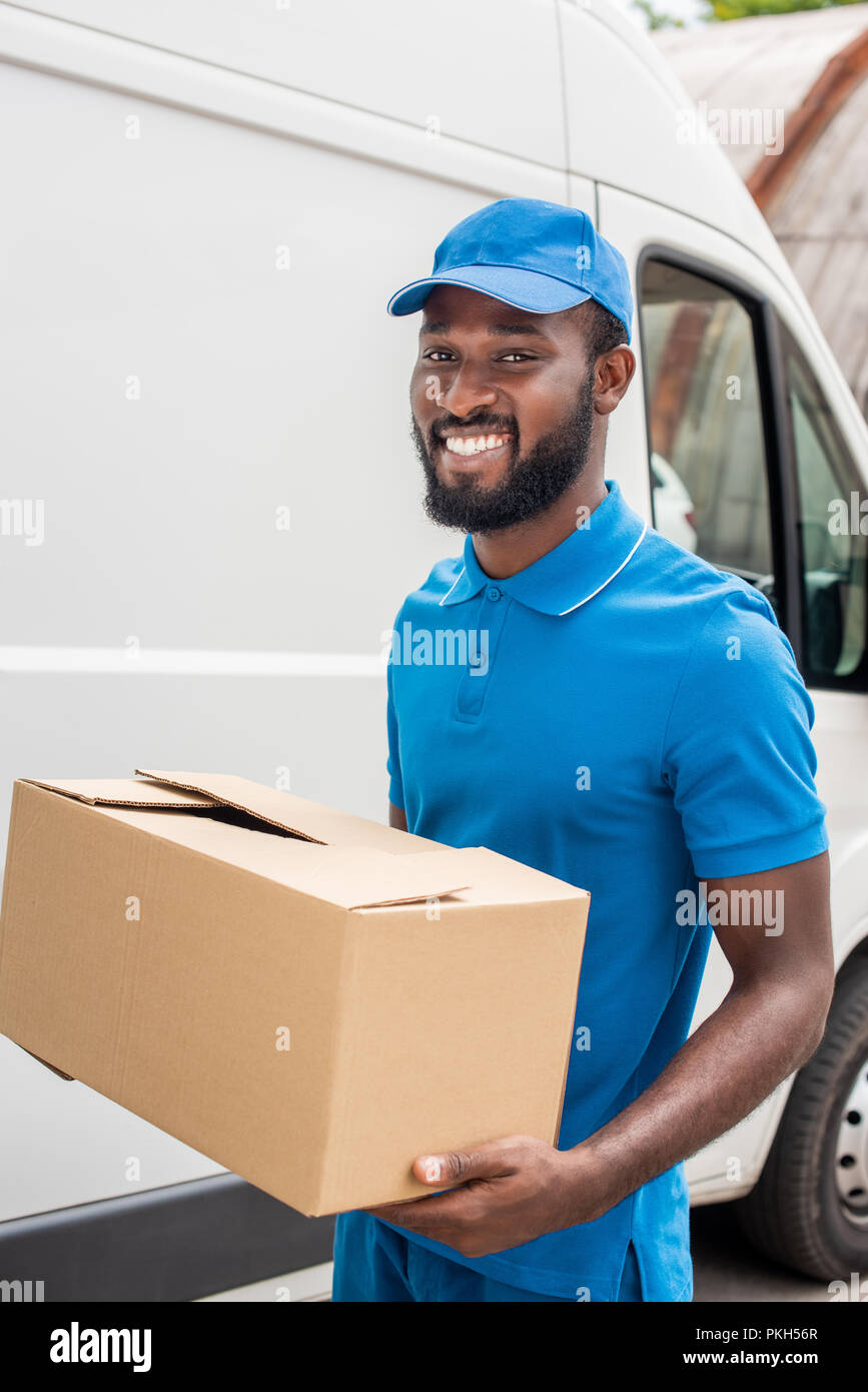 African american delivery man carrying hi-res stock photography and ...