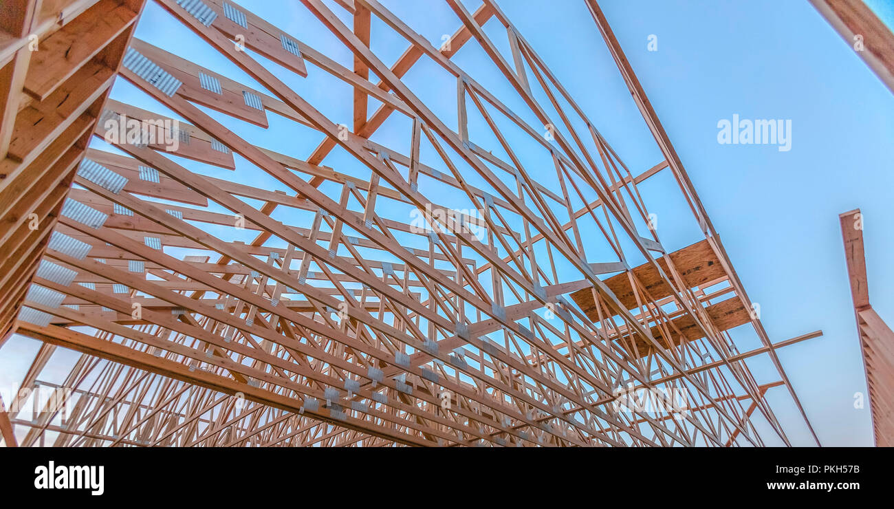 Looking up at new roof wood beams up pano Stock Photo - Alamy