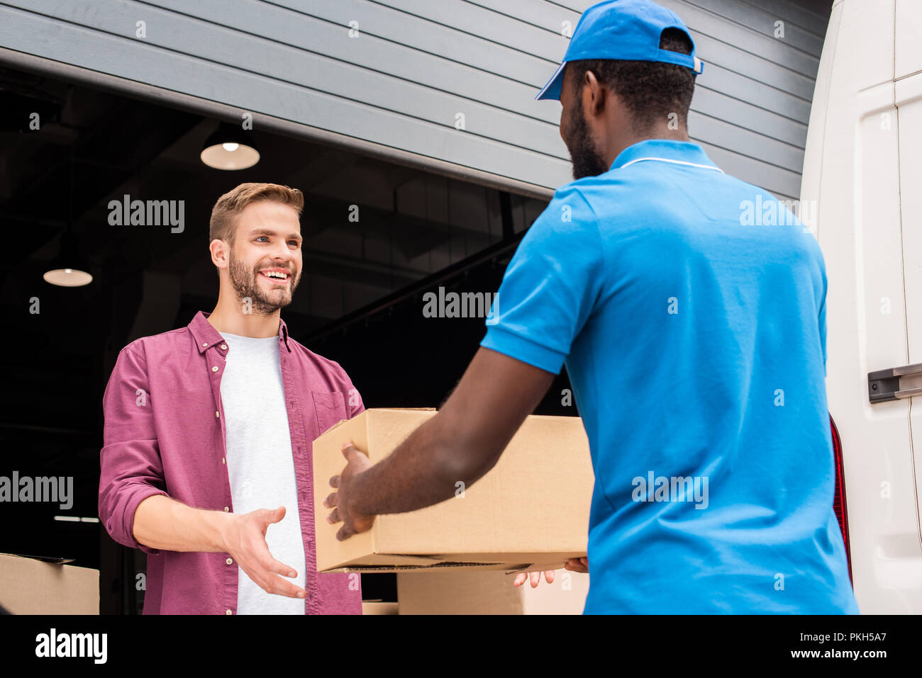 african american courier giving delivery box to customer Stock Photo ...