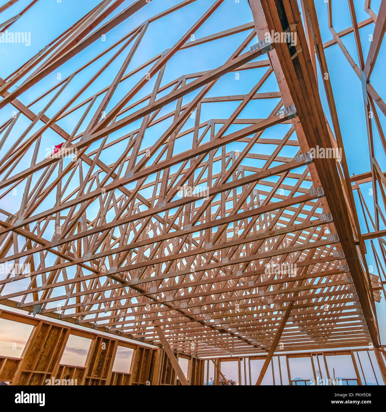 Looking up at new wood beams of building square Stock Photo - Alamy