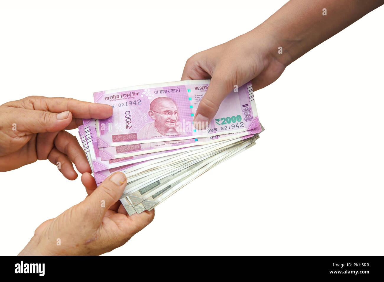 Hand Giving Indian 500 and 2000 Rupee Bank Notes over wheat background ...