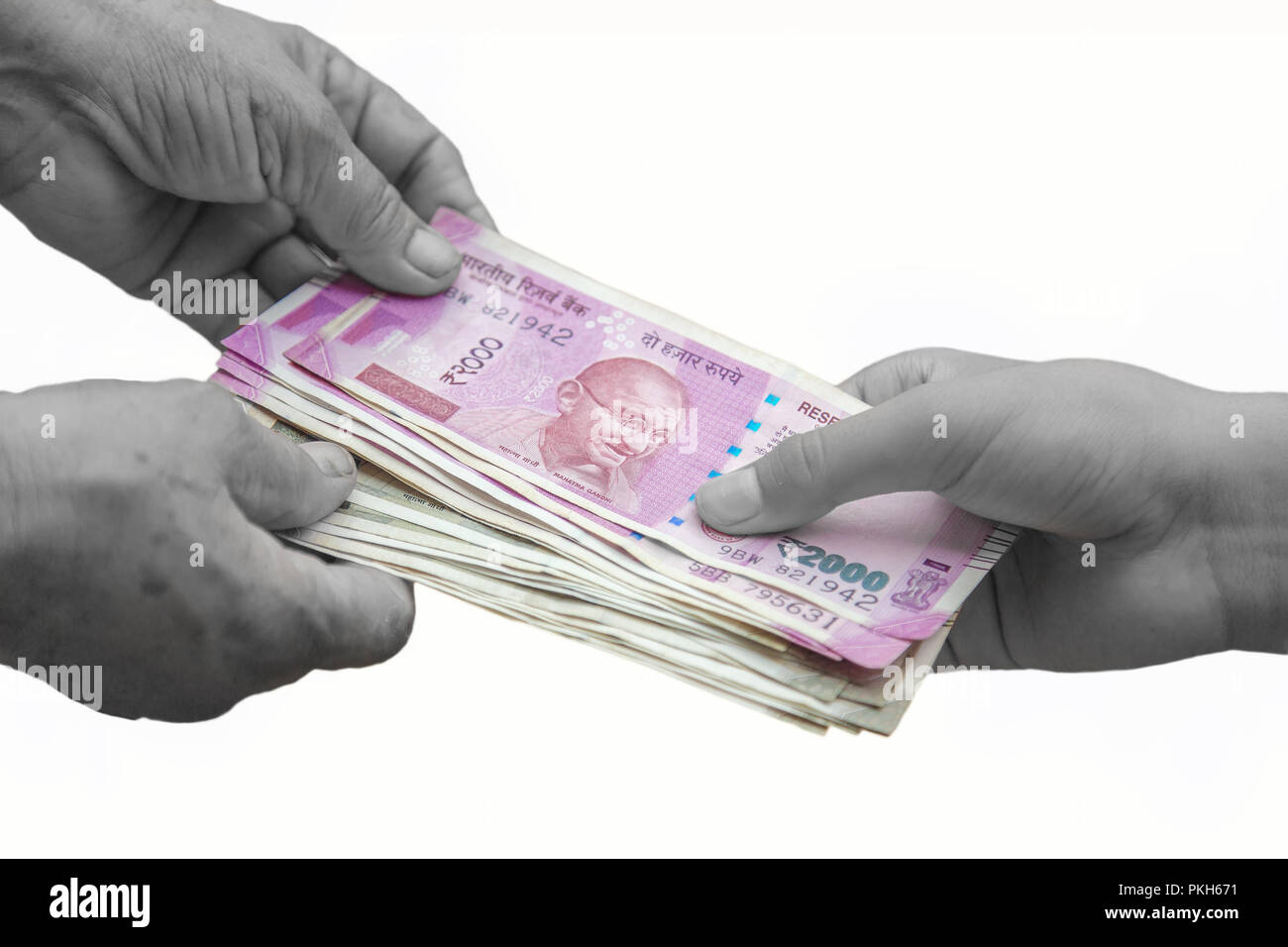 Hand Giving Indian 500 and 2000 Rupee Bank Notes over wheat background ...