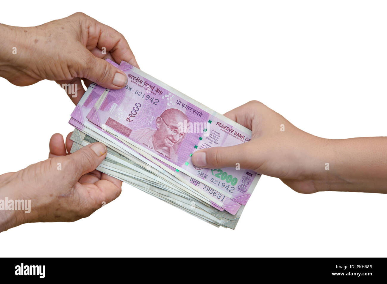 Hand Giving Indian 500 and 2000 Rupee Bank Notes over wheat background ...