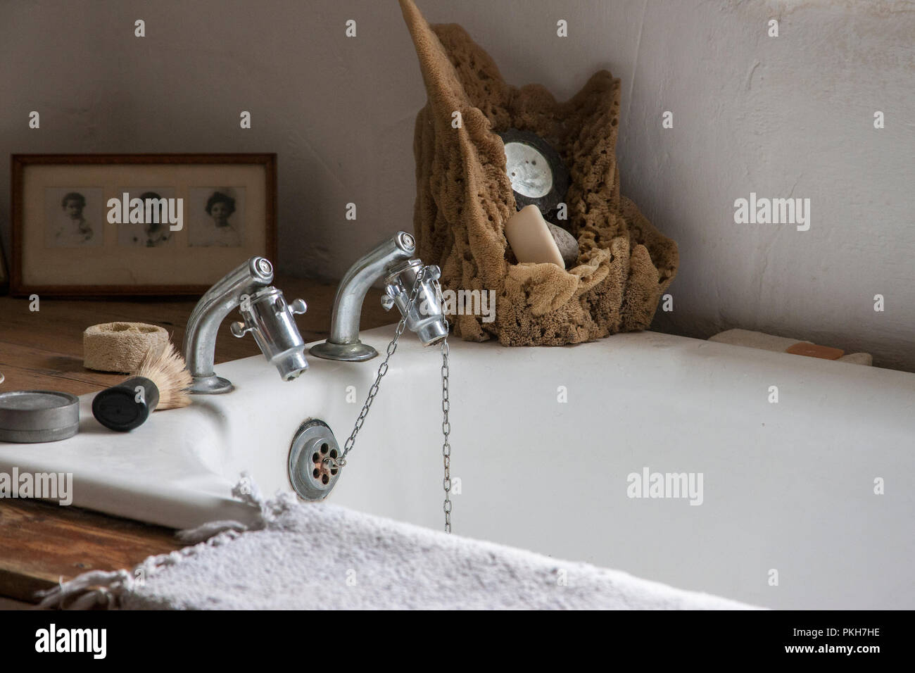 traditional bath with silver water taps shaving brush and plug chain ...