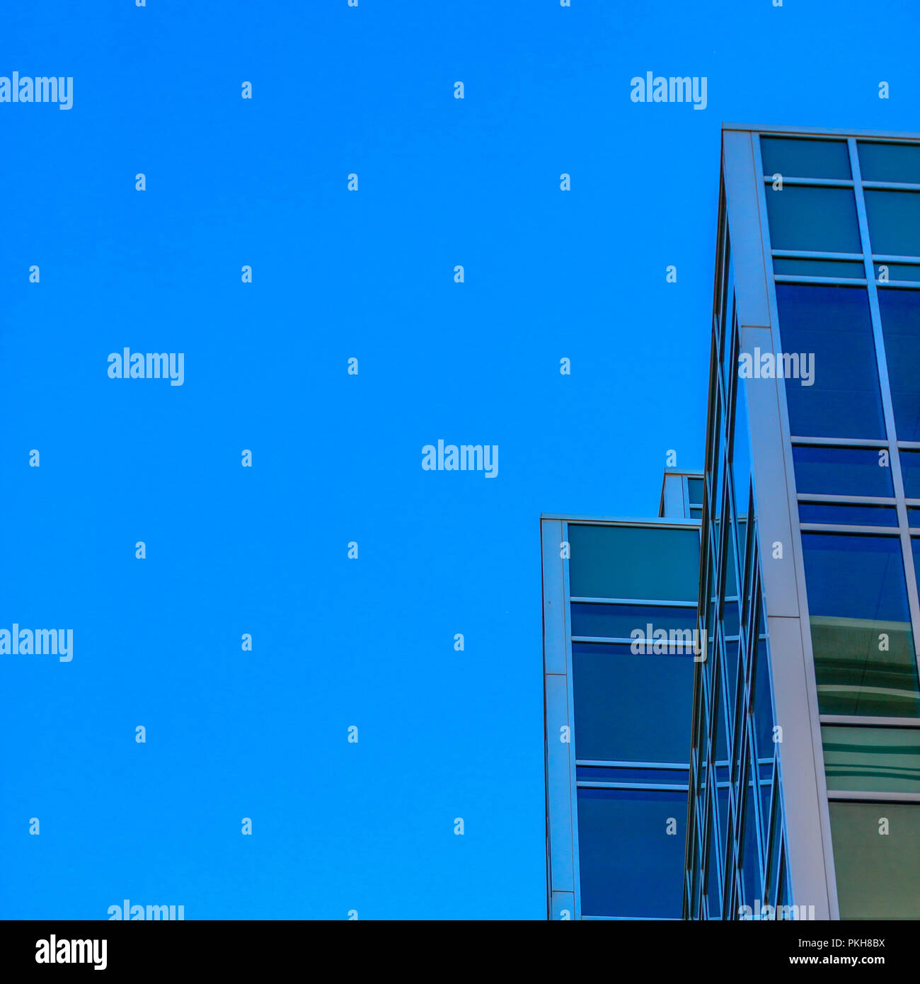 Sky reflected in windows of a modern building Stock Photo - Alamy
