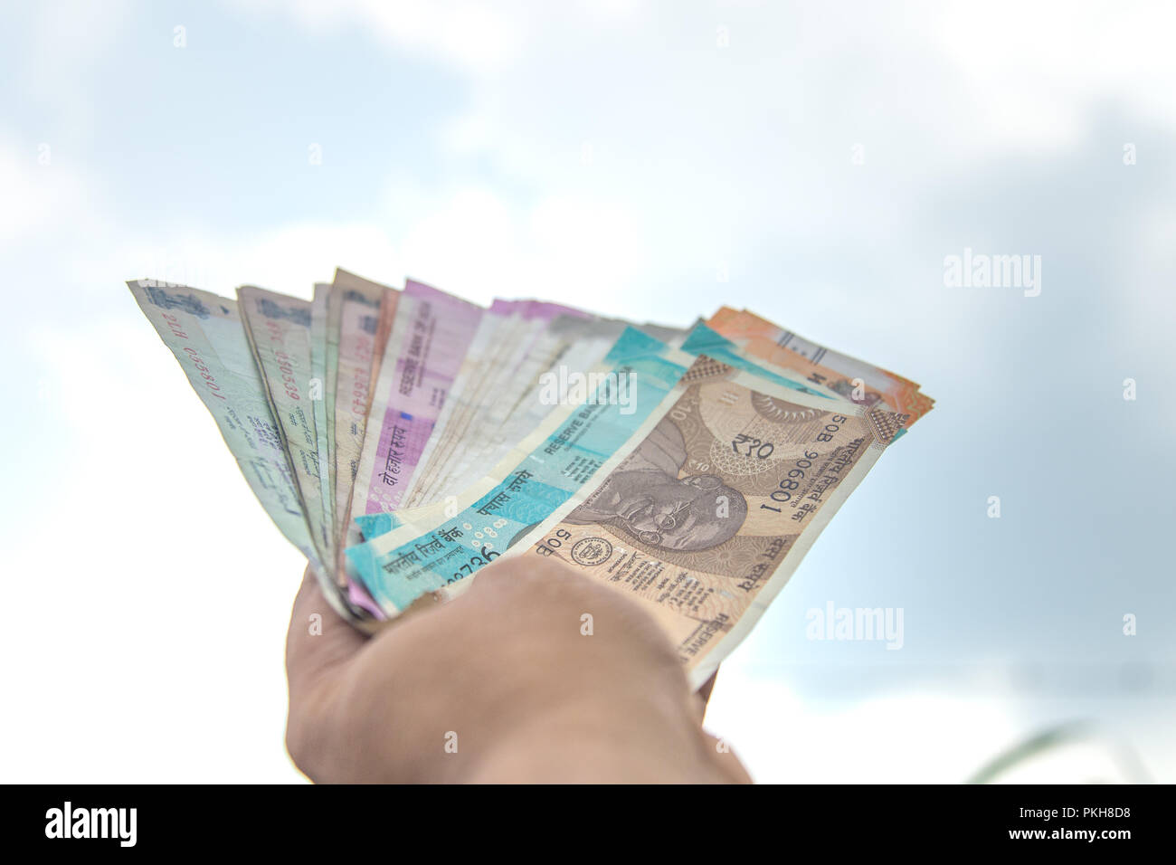 Indian Rupees in hand. Indian multiple currency note held in hand Stock ...