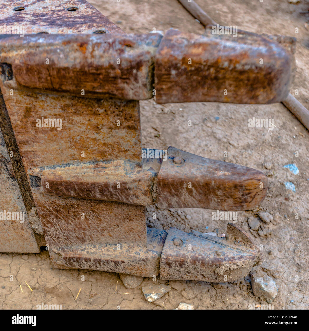 Tractor scooping claws on the edge detail square Stock Photo - Alamy