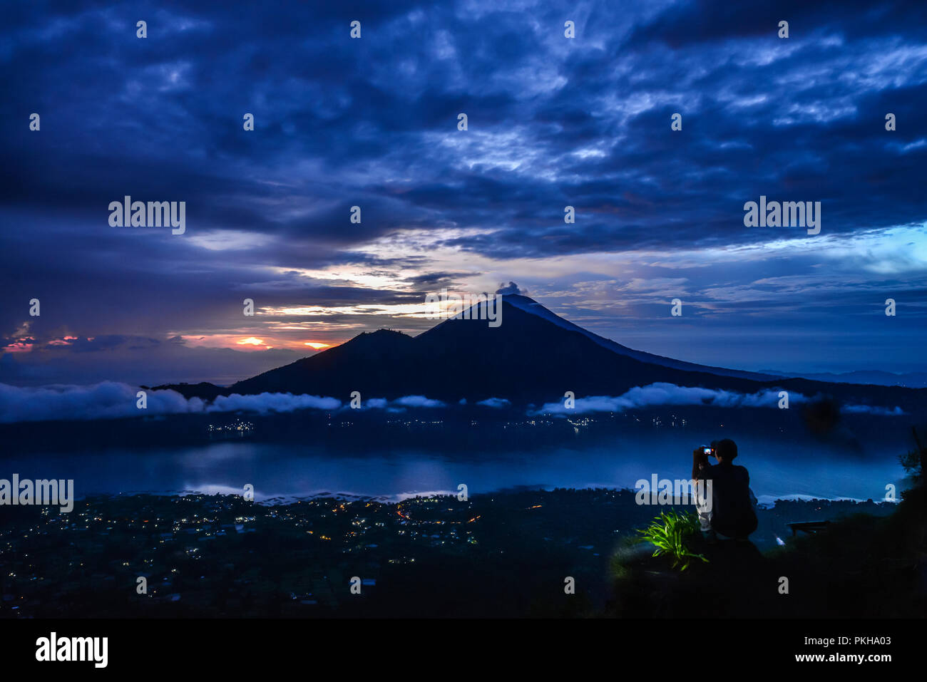 Man tacking picture of Agung volcano from the top of Batur volcano at ...