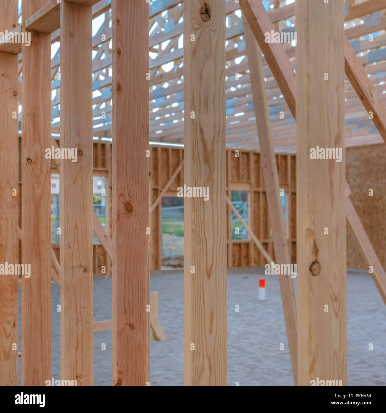 Vertical wooden beams with sandy ground square Stock Photo - Alamy