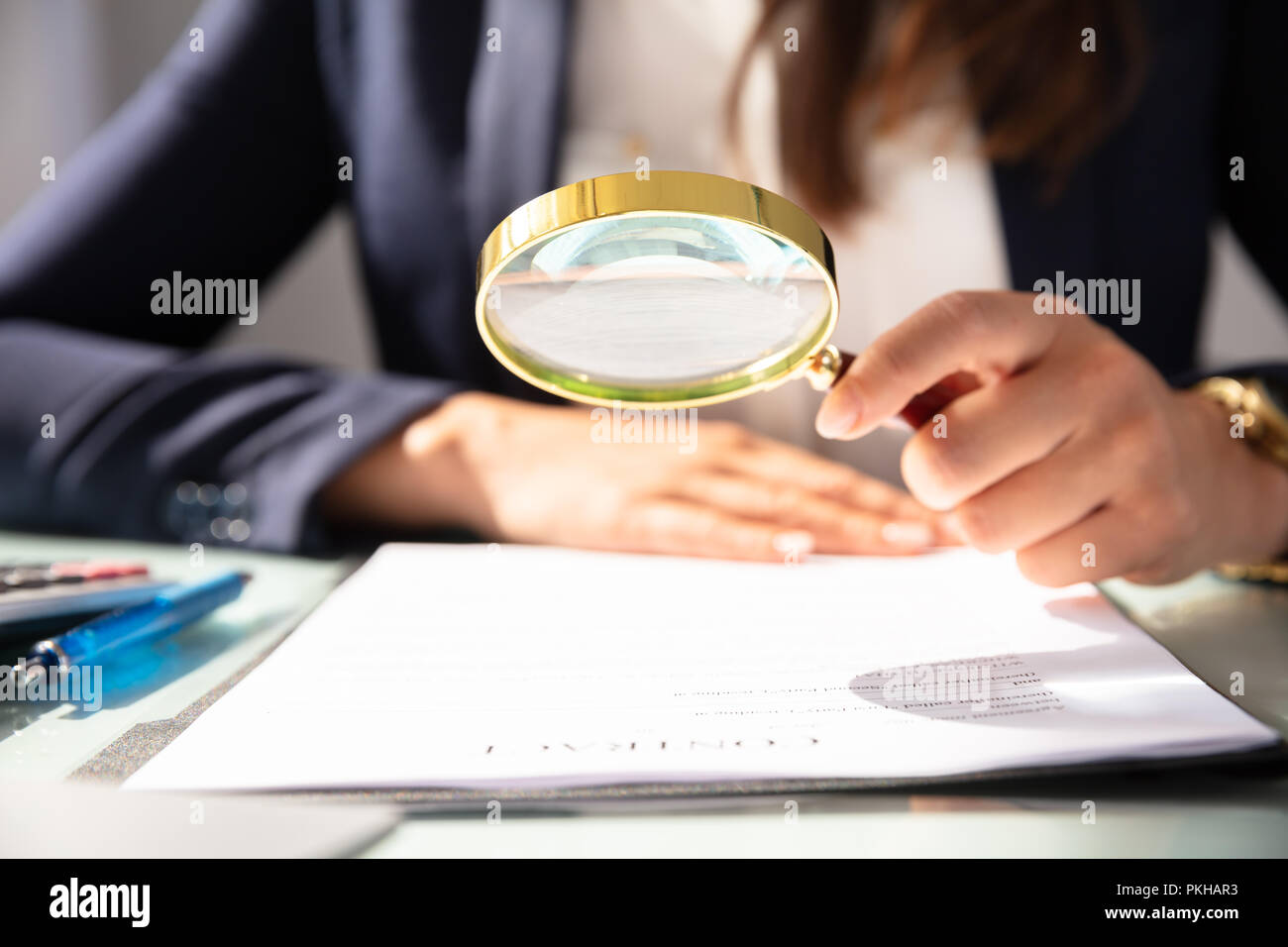 Close-up Of A Businesswoman's Hand Looking At Contract Form Through ...